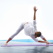 Demonstrating a perfect triangle pose | Buy Stock Photo on PeopleImages ...