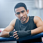 Young, fit and active man looking tired, sweating and breathing heavily ...