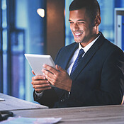 Business, office and man in technology on digital tablet by computer ...