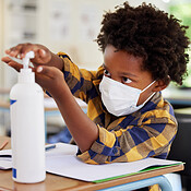 Student applying sanitizer in school class for hygiene, clean hands and ...