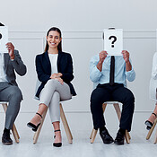 Job interview, question mark and feedback with business people sitting ...