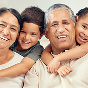 Grandkids hug grandparents for love, care and relax in family home ...