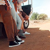 Legs, travel and friends on a road trip with a car for holiday in Kenya ...