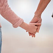 Holding hands to show support, love and care outdoor to show trust and ...