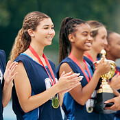 Netball team, clapping and medal, trophy and winner in sports ...