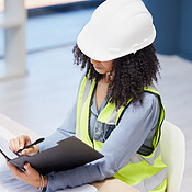 Document, writing and construction worker or engineer black woman ...