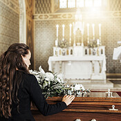 Funeral coffin, death and woman in church after the loss of family ...
