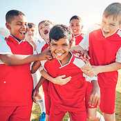 Soccer, winner or happy team of children for success, goal or ...