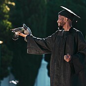 Black man, graduation and birds for achievement, success and goals of ...