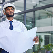 Black man, architect and blueprint in construction planning, thinking ...