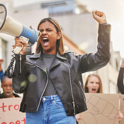 Protest, shouting and woman with megaphone in city marching for gender ...