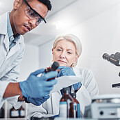 Science, research and team with medicine in laboratory working on ...