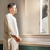 Prayer, reflection and muslim man in mosque with mirror in Saudi Arabia ...