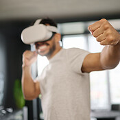 VR, metaverse and man boxing on a game, training for a fight and match ...