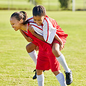 Girl soccer player, happy celebration and grass with piggyback for goal ...