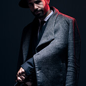 Gangster, portrait and holding gun on studio background in dark secret ...