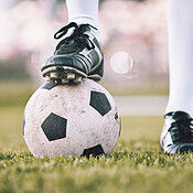 Soccer ball, football player shoes and grass field of athlete feet ...