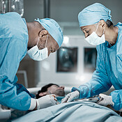 Healthcare, surgery and doctors in hospital operating room for ...