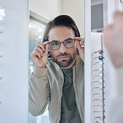 Optometry, glasses choice and man check mirror for vision, eye care and ...