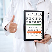 Hands thumbs up, tablet screen and eye chart in hospital for vision ...