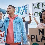 Protest, environment and megaphone with man at the beach for climate ...