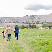 Agriculture, field in countryside with people walking on farm and back ...
