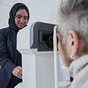 Optometrist, muslim woman and testing eyesight health in optometry lab ...