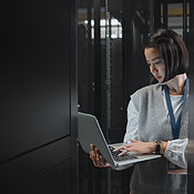 Woman with laptop, datacenter and information technology, engineer and ...