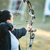 Archery woman, target and bow and arrow training for outdoor sports ...