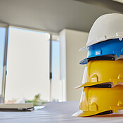 Building, helmets and architect equipment on table for construction ...