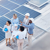 Solar energy, teamwork or engineering team on roof by solar panels for ...