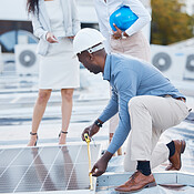 Black man, roof and solar panel installation team of construction ...