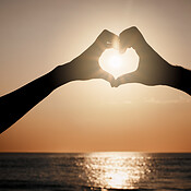 Beach silhouette, sunset and heart hand sign for travel freedom ...