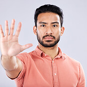 Stop, serious and portrait of an Asian man with a hand isolated on a ...