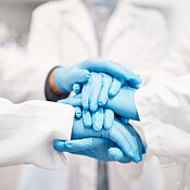 Doctor, team and hands together with gloves in healthcare, partnership ...