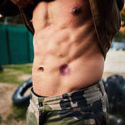 Paintball, injury and man with wound on abdomen, military game and ...