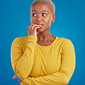 Nervous, worried and scared black woman in fear and bitting nails ...