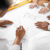 Hands, collaboration and architecture with a building team working in ...