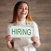Woman, portrait and hiring sign for small business recruitment, career ...
