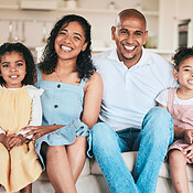 Family in portrait, parents and children are happy and relax at home ...