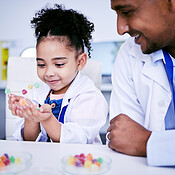 Science, research and child with her father in the lab working on an ...