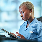 Security, working and black woman with tablet at a desk for ...