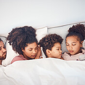 Sleeping, above and family in a bed with love, dreaming and resting in ...