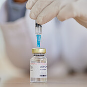 Smallpox vaccine, vial and hands of doctor for safety, healthcare or ...