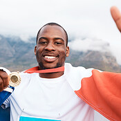 Winner portrait, flag or black man with gold medal, emoji sign and pose ...