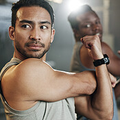 Men at gym together, stretching arms and muscle building strong body ...