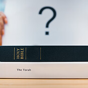 Books, stack and closeup on desk for faith, Abrahamic religion and ...
