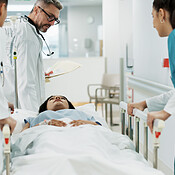Doctors, patient and people push hospital bed, consulting and talking ...