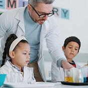 Chemistry, teacher and students with education, classroom and science ...