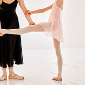 Closeup, ballet and mentor with girl, balance and practice for ...